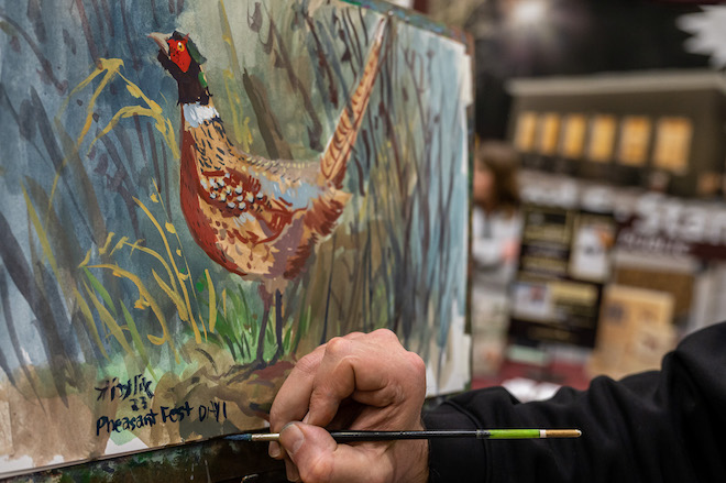 Artist Kickliy roamed the show floor painting his signature real-time ...